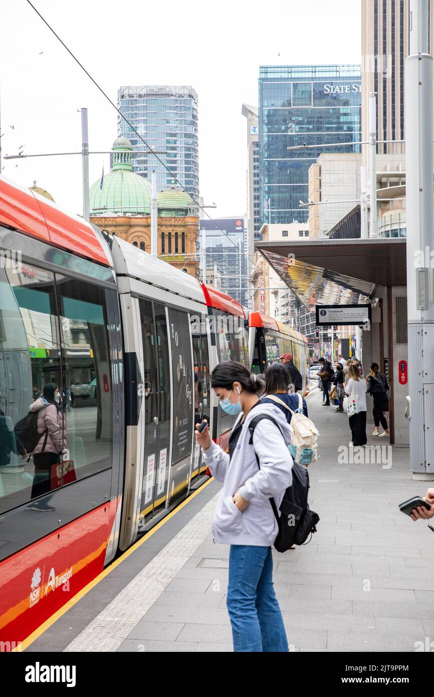 Sydney CBD light rail train at Town Hall station ,lady wearing facemask ...