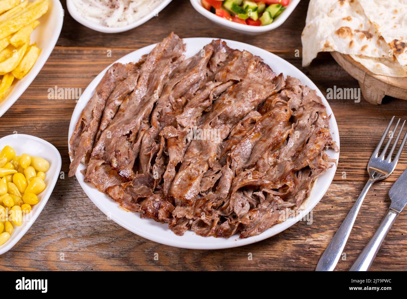 Meat doner kebab on the plate. Turkish meat doner kebab on wooden background. Traditional ...