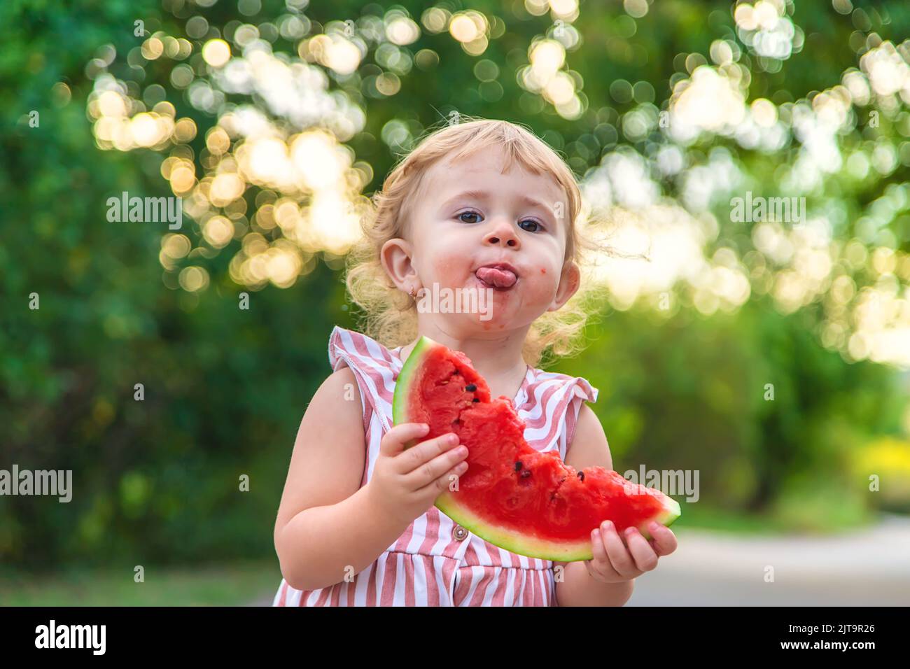 Child girl eats watermelon in summer. Selective focus Stock Photo - Alamy