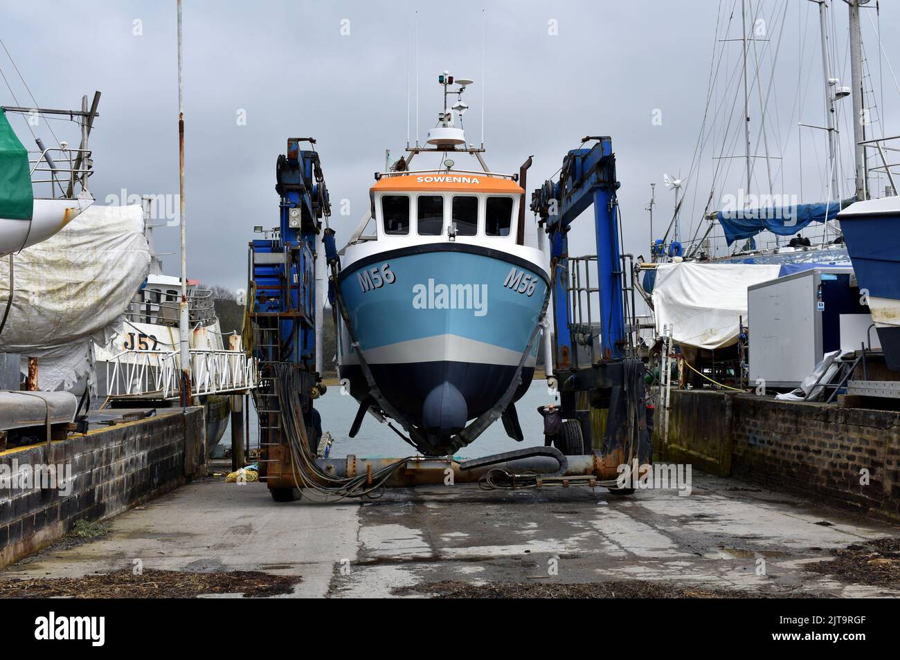 Fishing boat in a travel hoist being launched back in the water, East ...