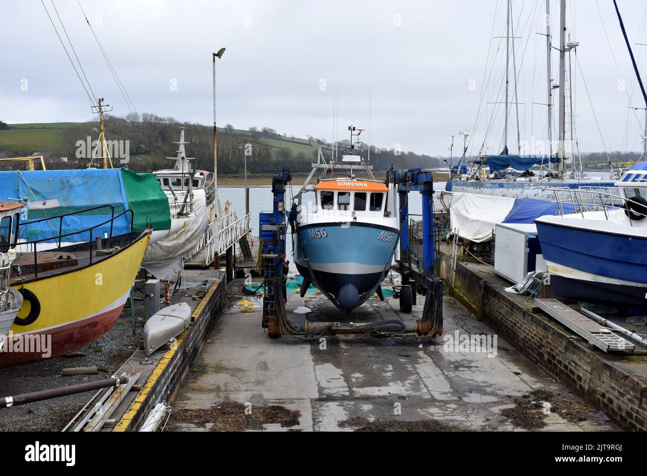 Fishing boat in a travel hoist waiting to be launched back in the water ...