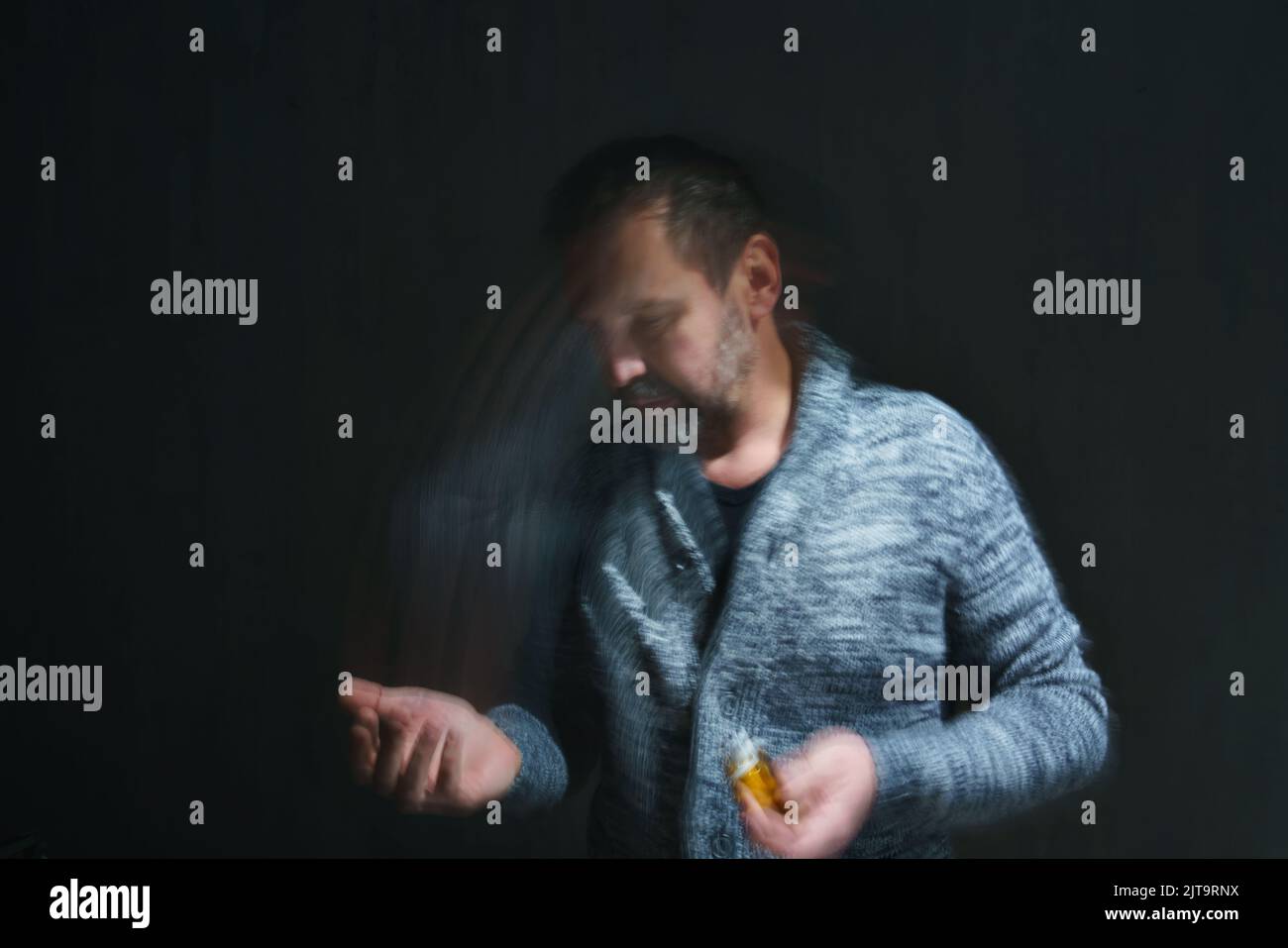Mature man taking drug pill on dark background, mental health concept ...