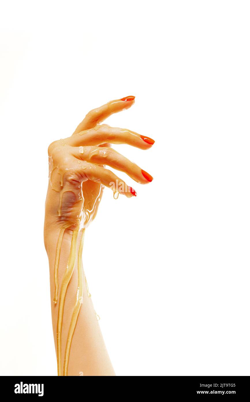 Oil running down the hand. Sensual female hand isolated on white studio ...