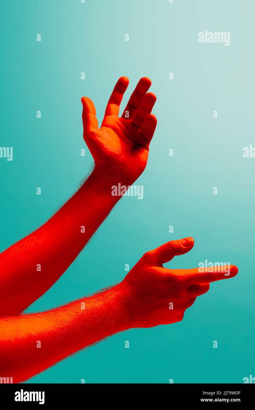 Pointing. Authentic hands gesturing isolated on cyan color background ...