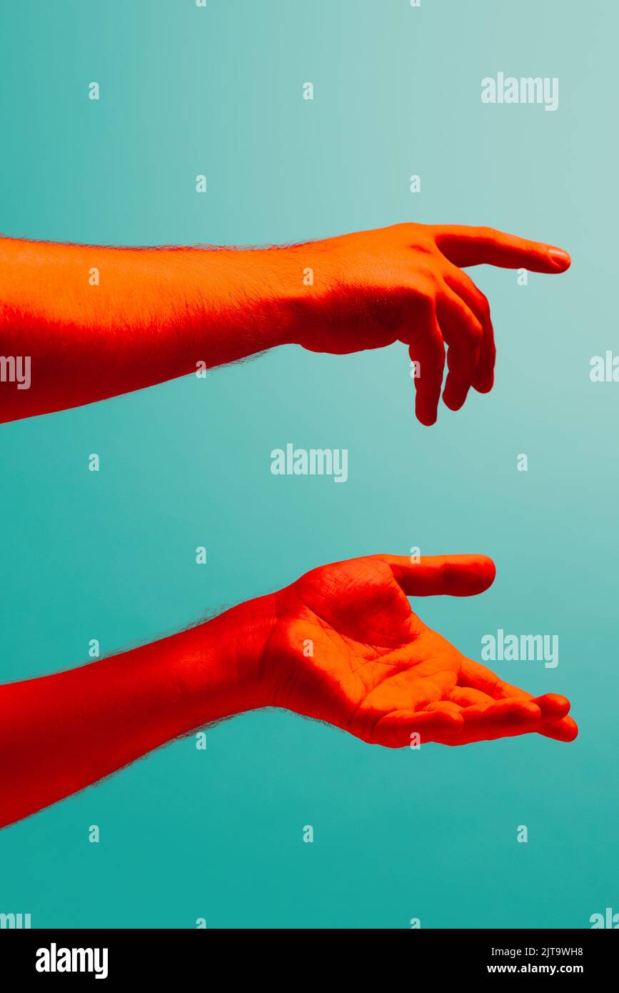 Advice. Male hands gesturing isolated on cyan color background in red ...