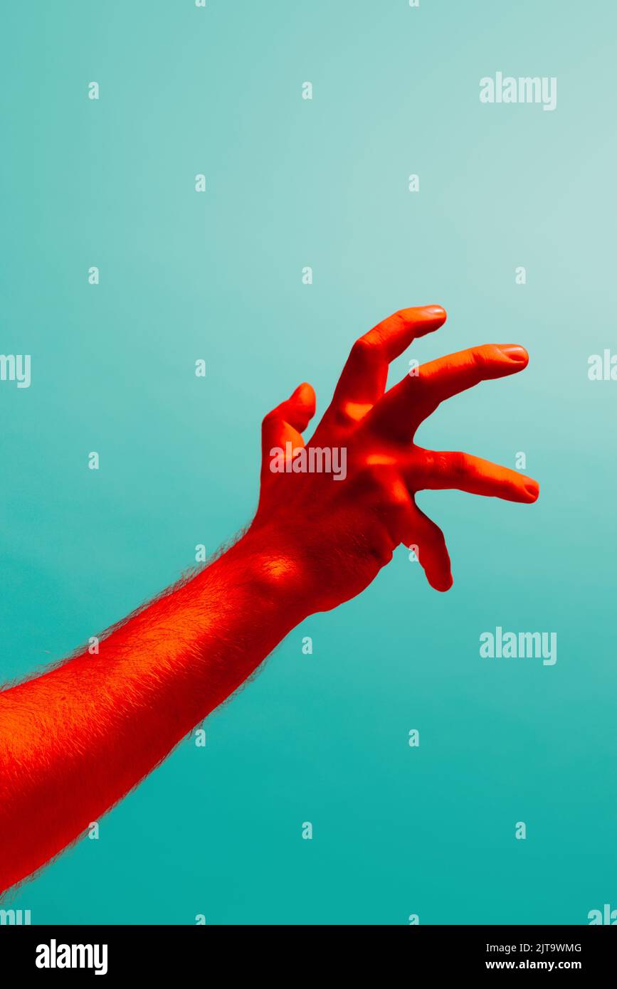 Fear. Authentic hands gesturing isolated on cyan color background in ...