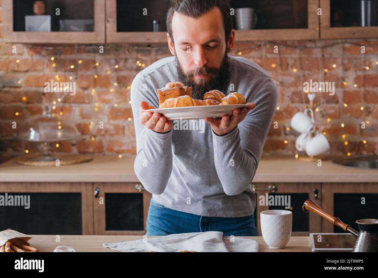 homemade sweet bakery man smelling fresh pastries Stock Photo - Alamy