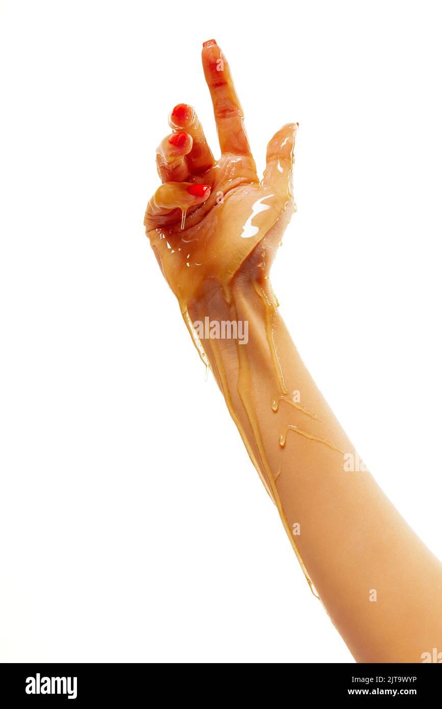 Honey running down the hand. Sensual female hand isolated on white ...