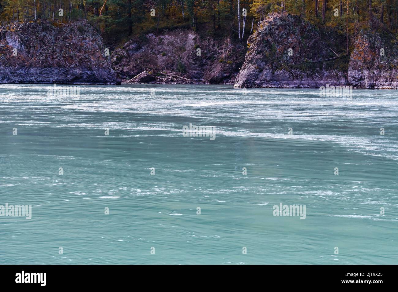 Blue mountain river flowing between Rocks with yellow trees, mountain ...