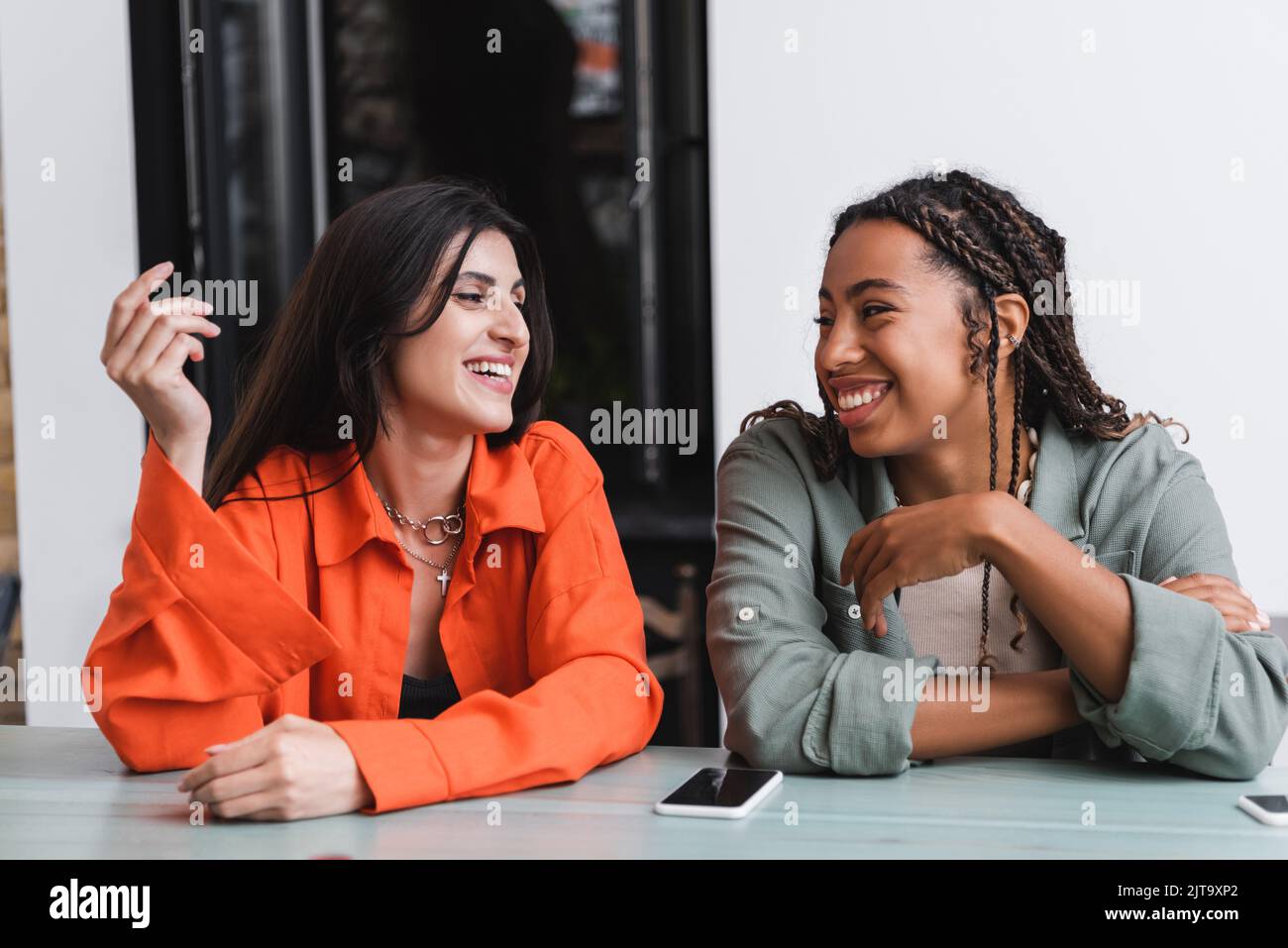 Friends talking to cellphones happy hi-res stock photography and images ...