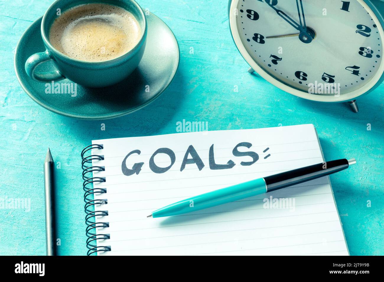 Goal setting. A notepad with the handwritten word Goals, with a pen, an ...