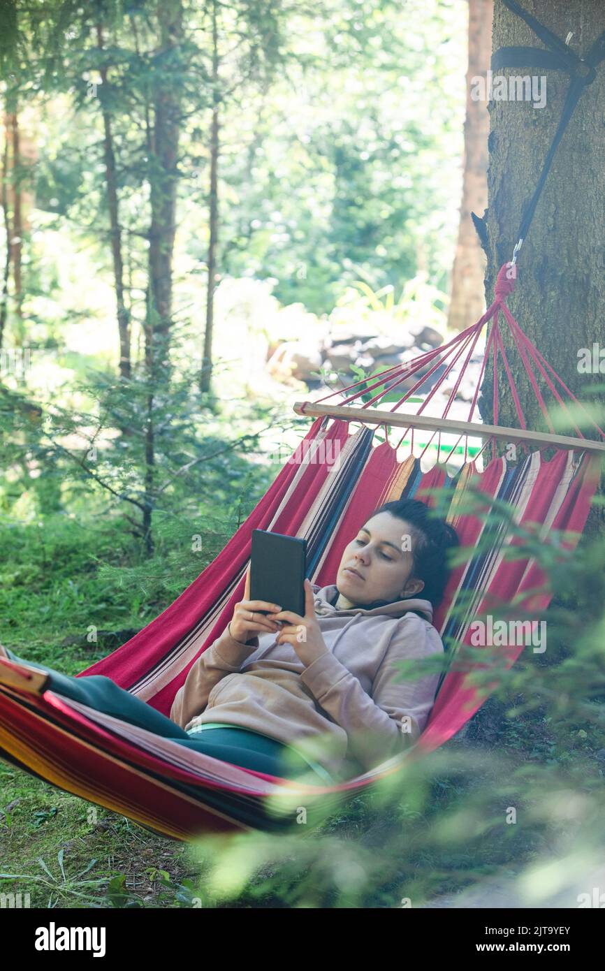 Woman laying down in hammock hi-res stock photography and images - Alamy