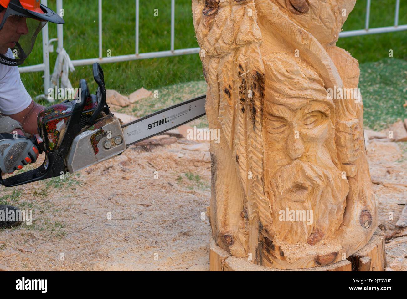 Carpenter using chainsaw for carving wooden sculpture Stock Photo - Alamy