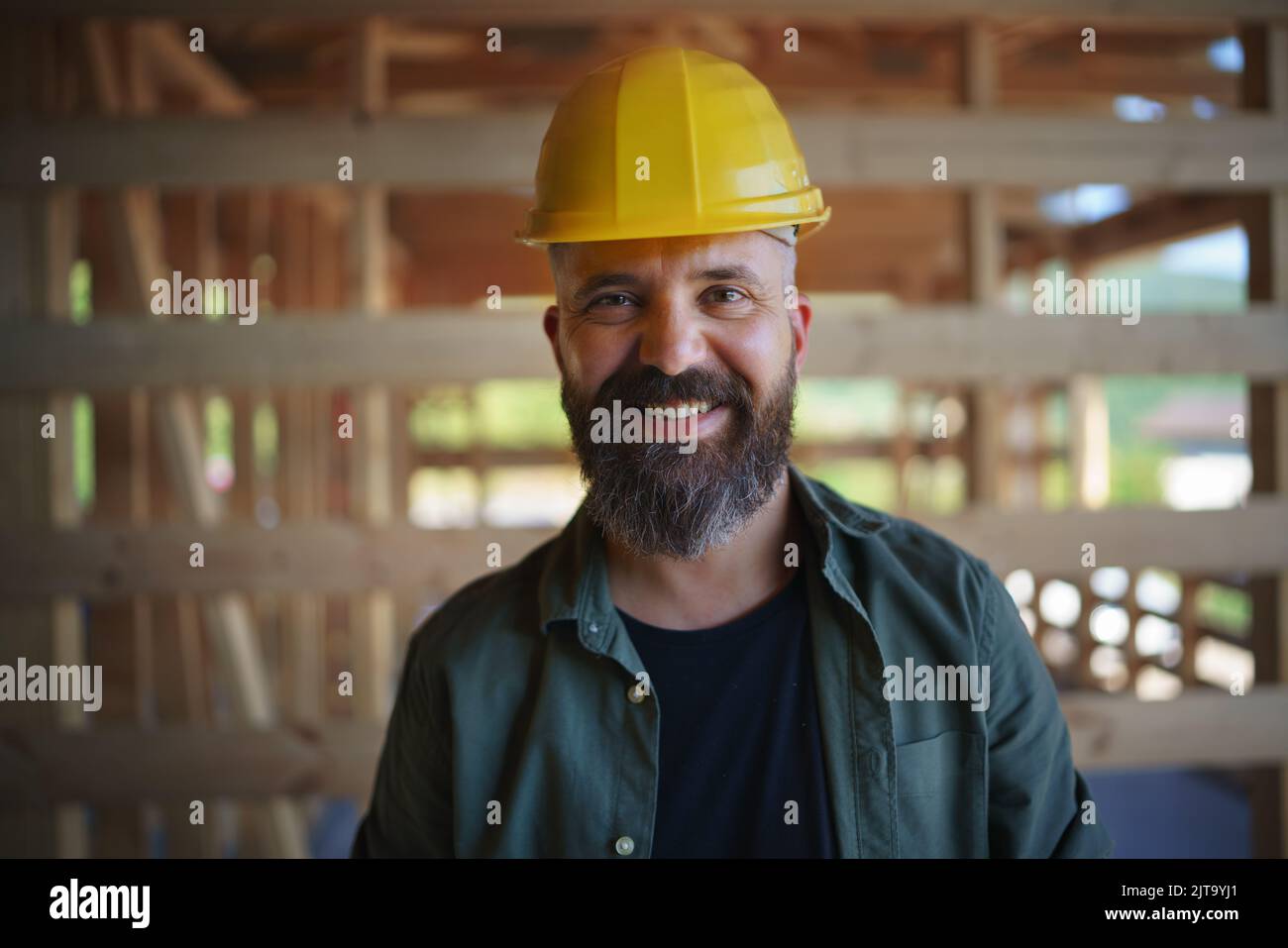 Portrait of construction worker smiling and looking at camera, diy eco ...