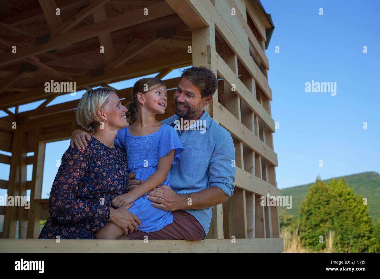 Young family on site inside new home construction framing Stock Photo ...