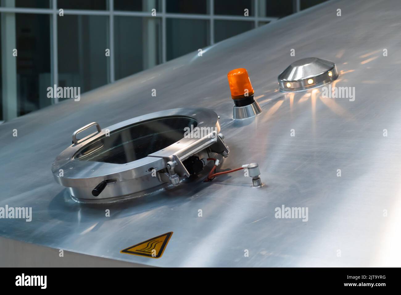 Pressure glass manhole on steel vessel for wort boiling Stock Photo - Alamy