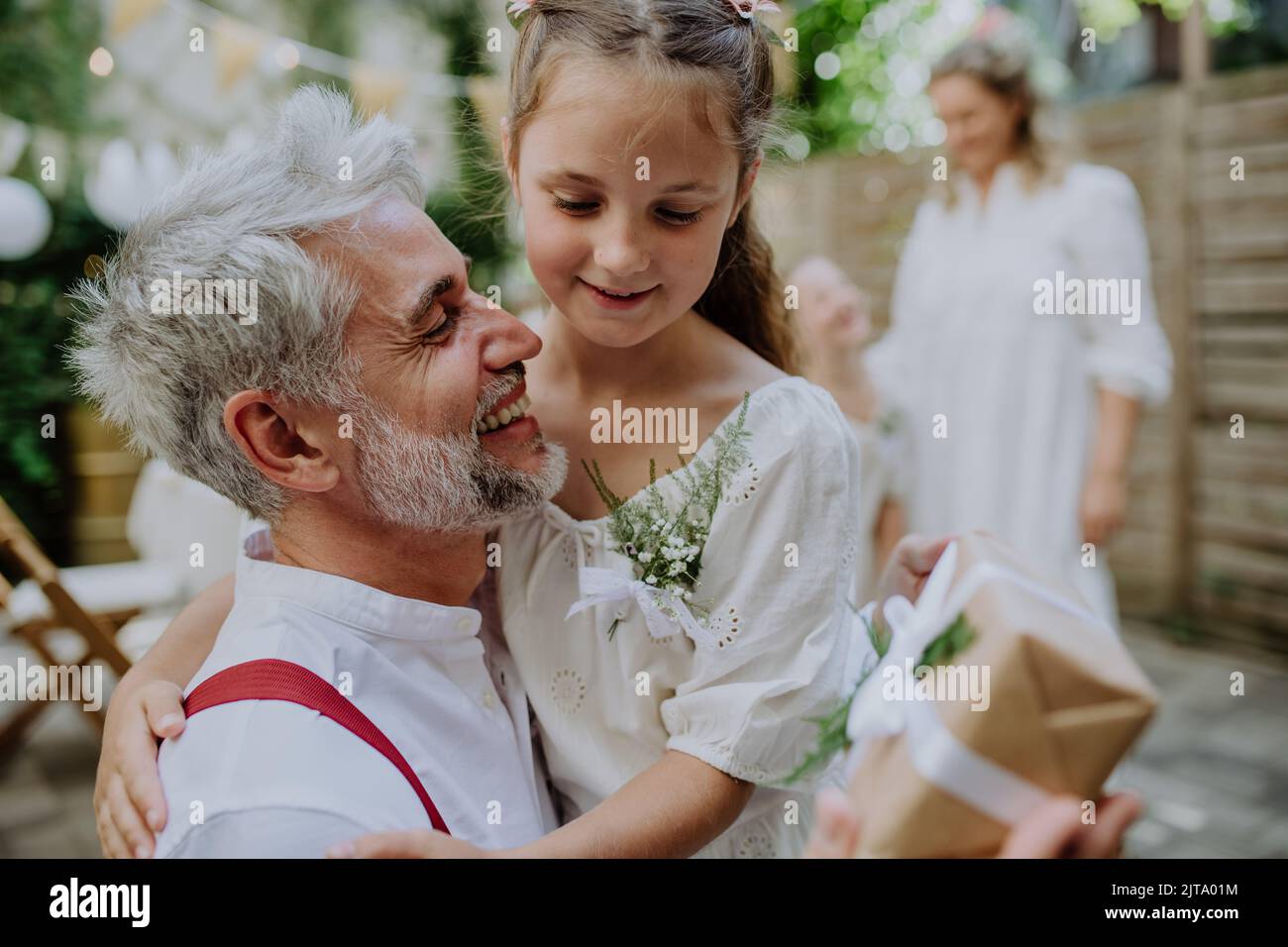 Mature father groom receiving gift from his daughter at wedding ...