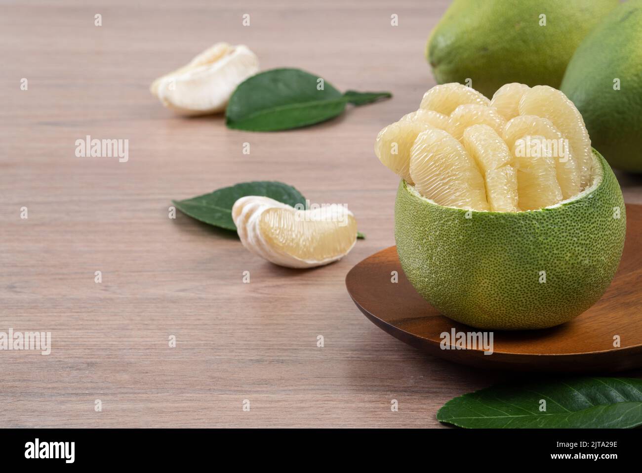 Close up of fresh peeled pomelo on wooden table background for Mid ...