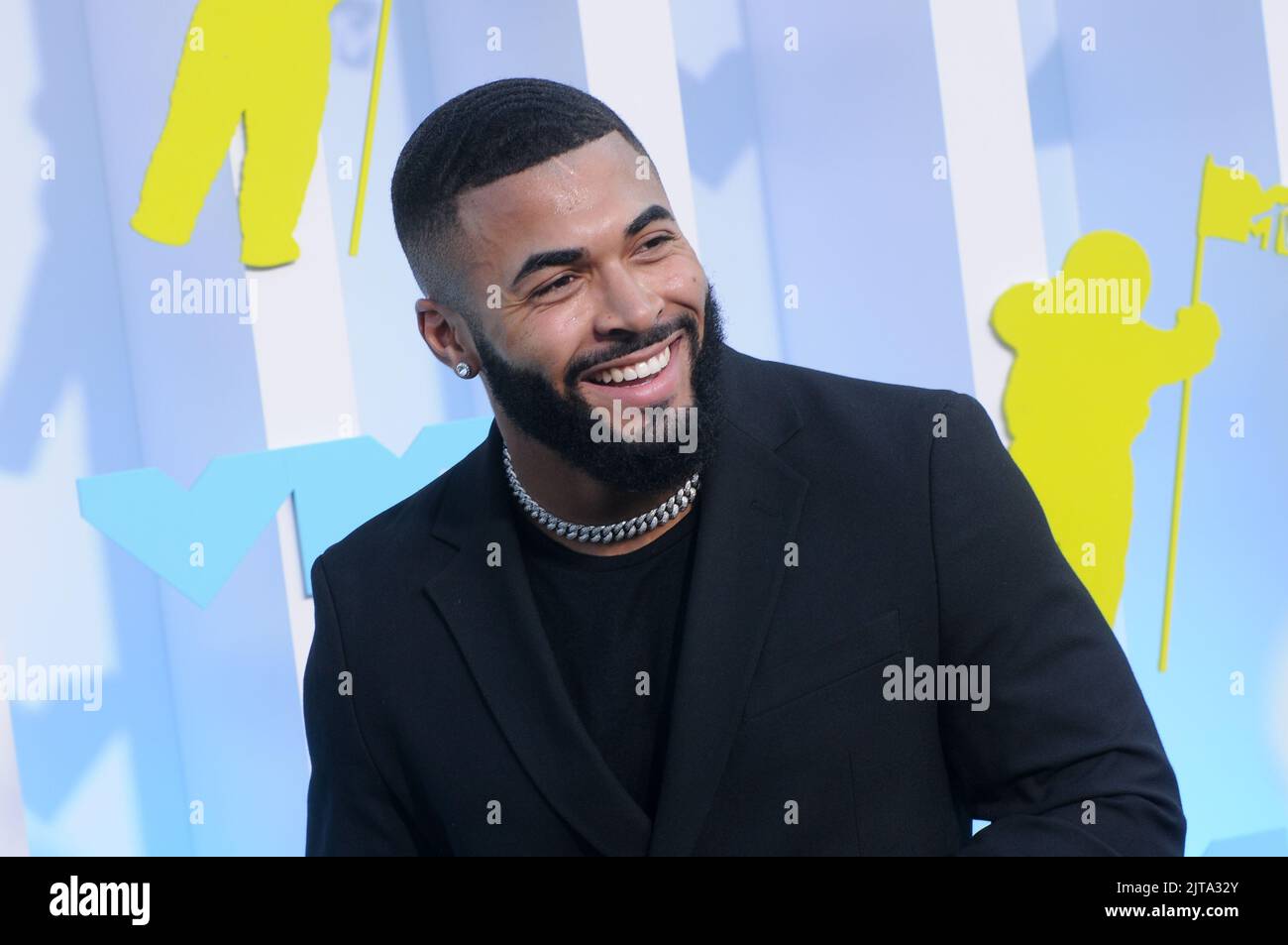 Johnny Middlebrooks walking on the black carpet at the 2022 MTV Video ...