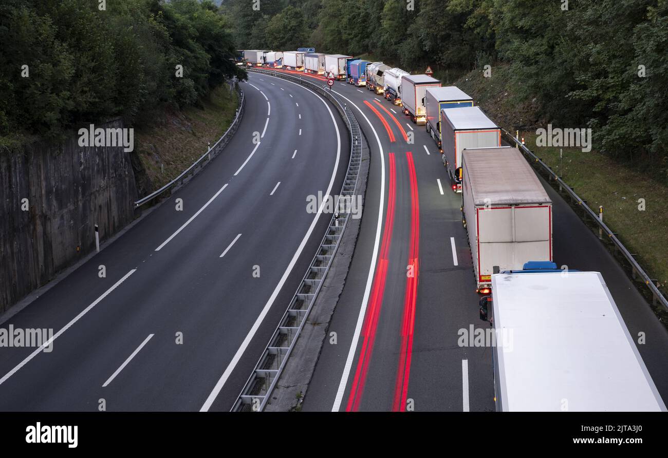 stack of trucks in a long traffic jam on the freeway at night Stock ...
