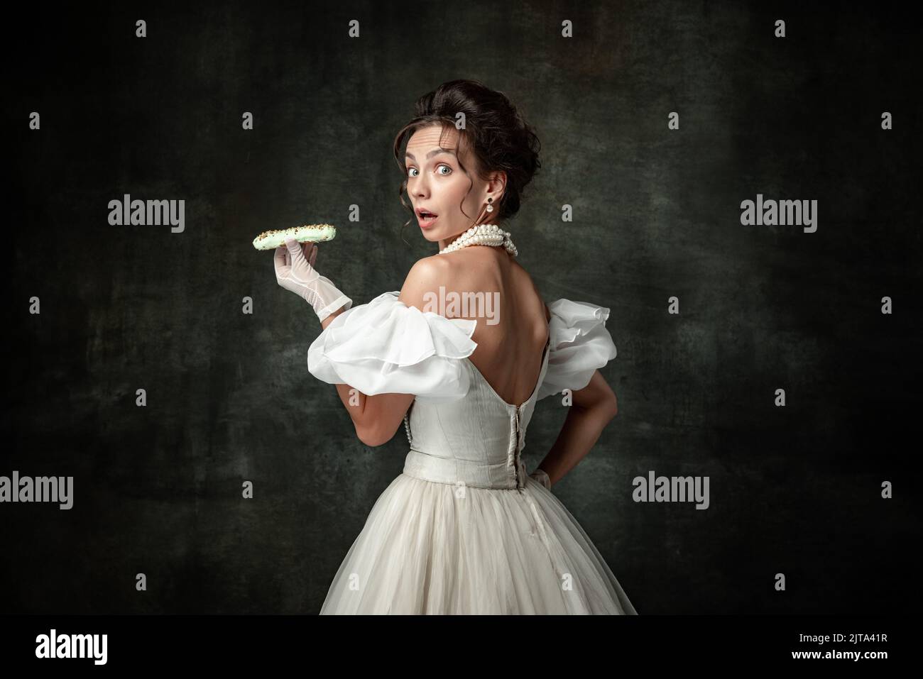 Shock. Young scared adorable girl in image of medieval royal person or ...