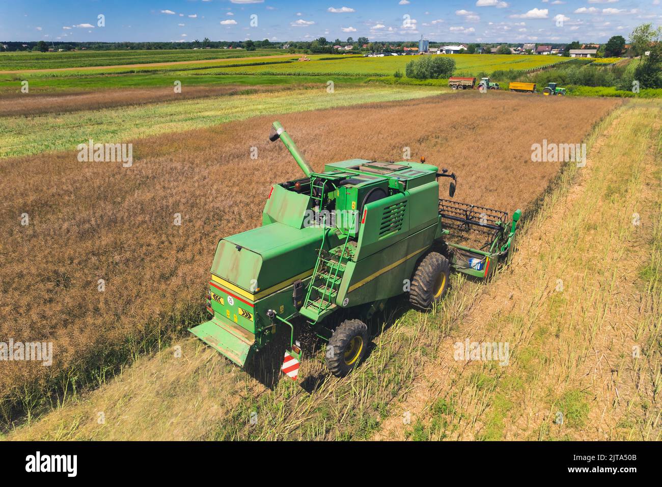 Aerial view of a green agricultural combine with a revolving reel ...