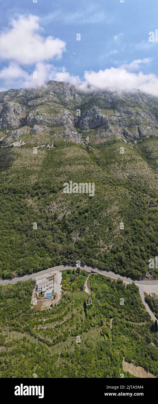 An aerial panoramic view of mountain forests in coastal Budva town in ...