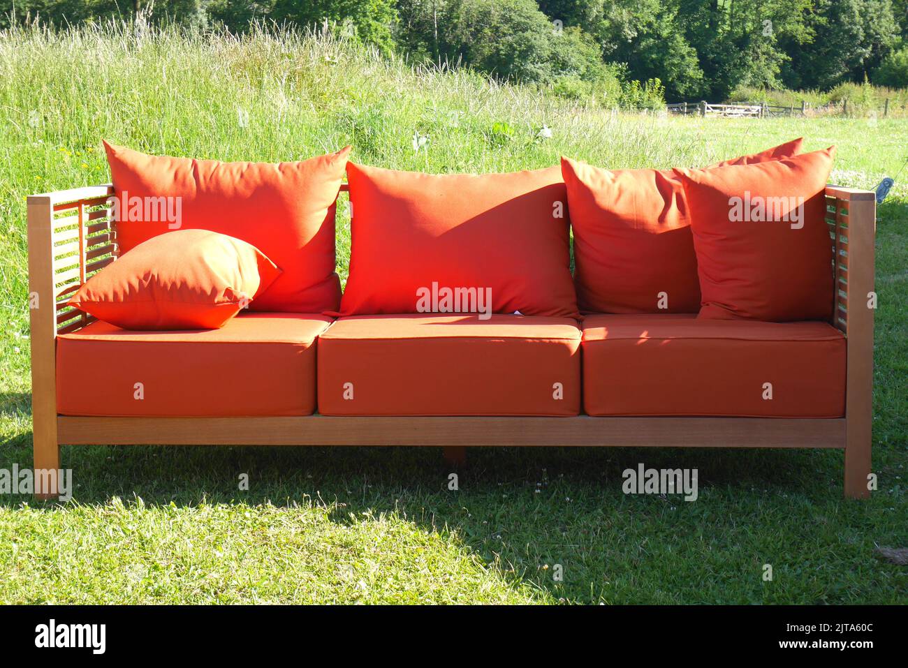 Orange sofa in a field, Herefordshire, England Stock Photo - Alamy