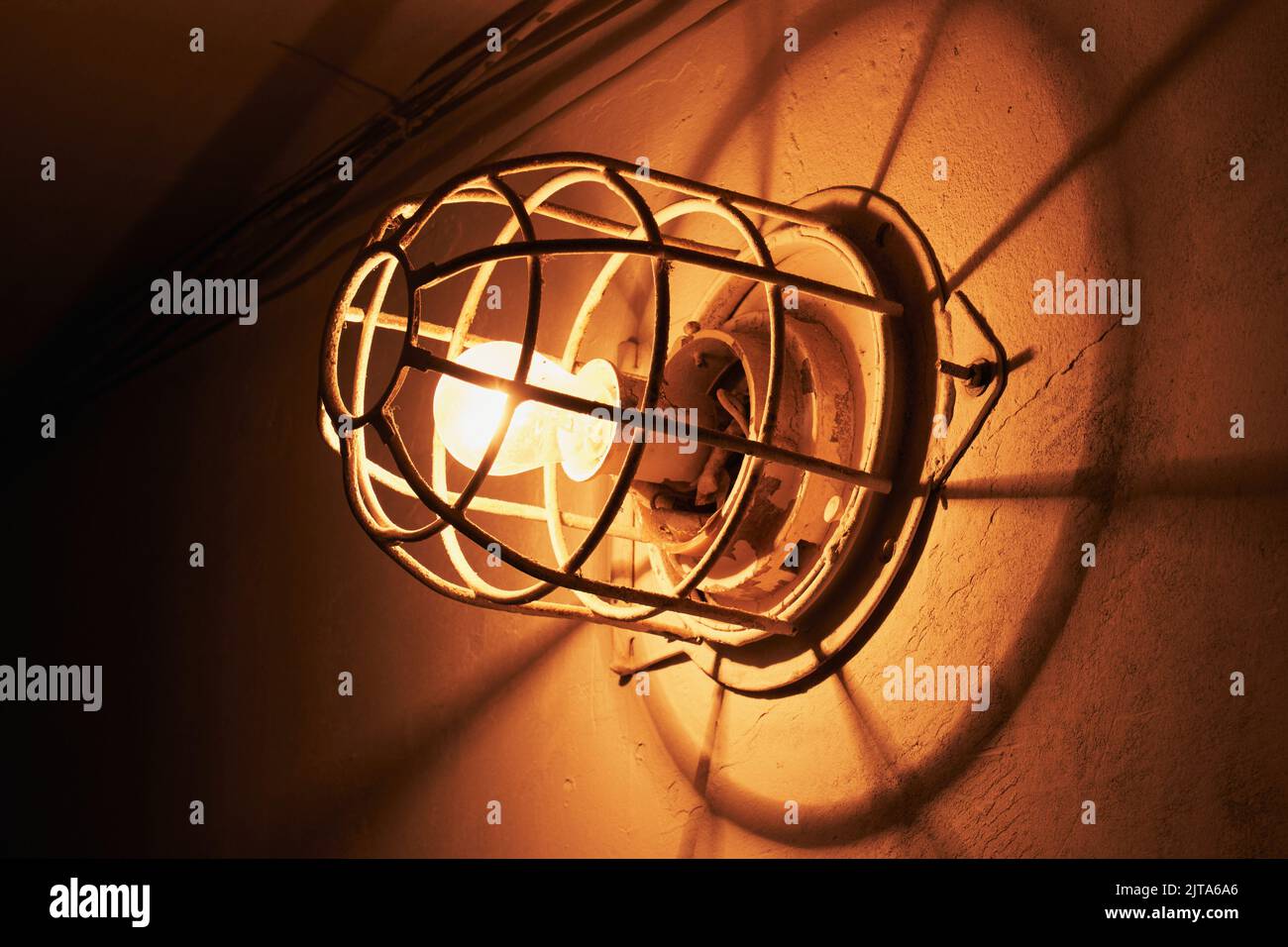 Old electric light bulb with a metal cap on the wall Stock Photo - Alamy