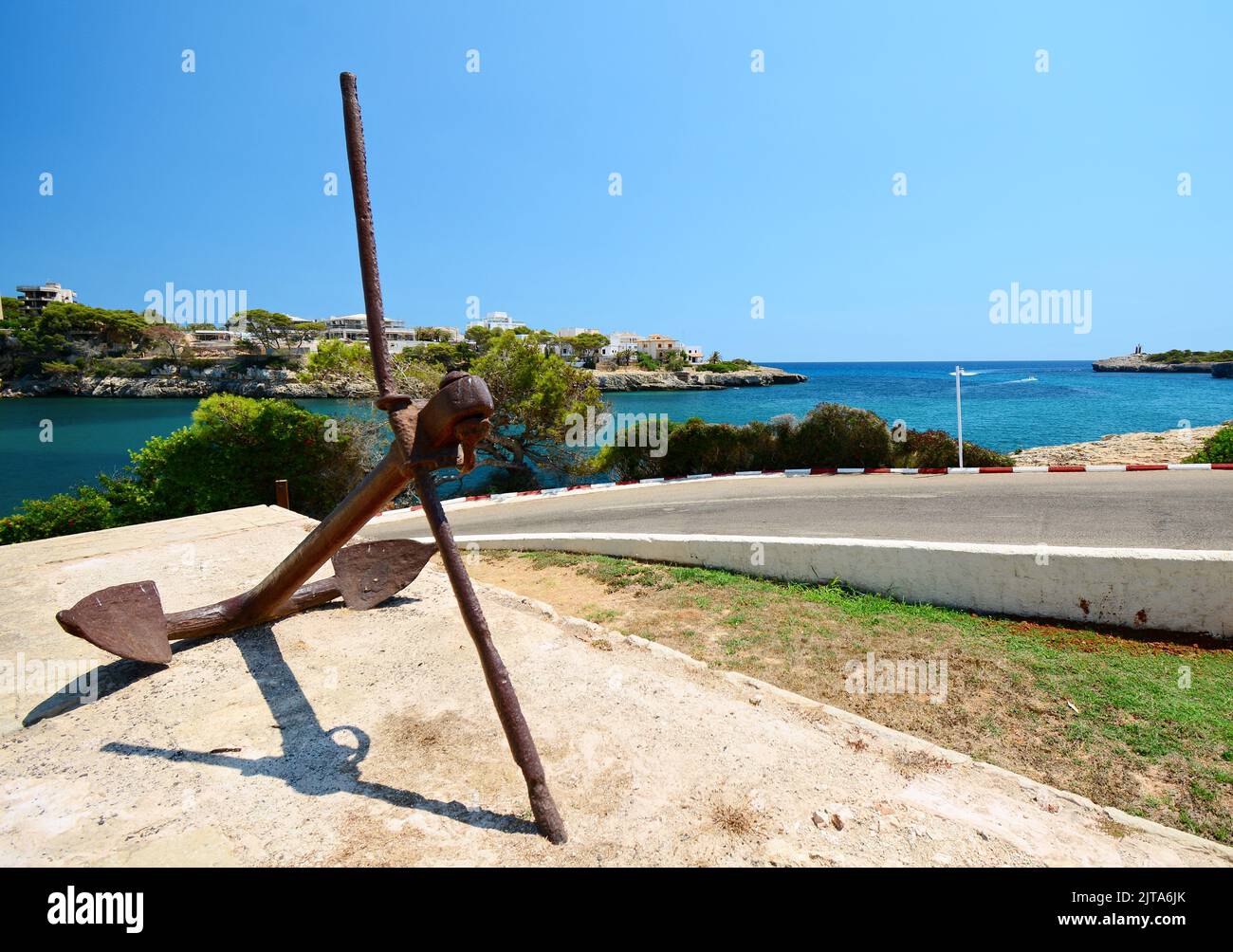 Wide angle view of big iron anchor near harbor of Porto Cristo town in ...