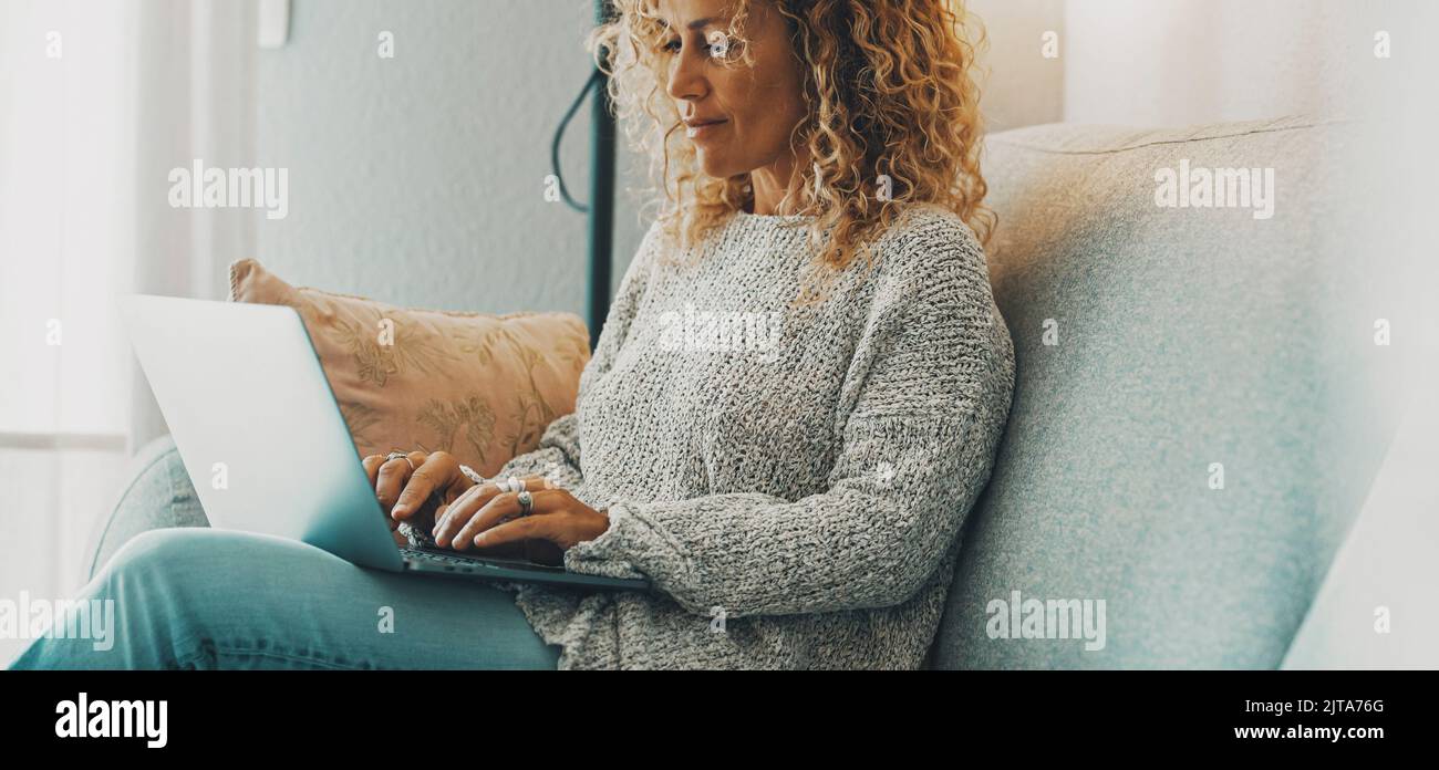 Horizontal banner image with young mature woman using laptop sitting on ...