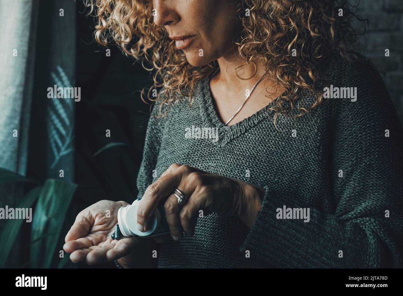 Close up of woman taking pills alone at home. Vitamins and diet ...