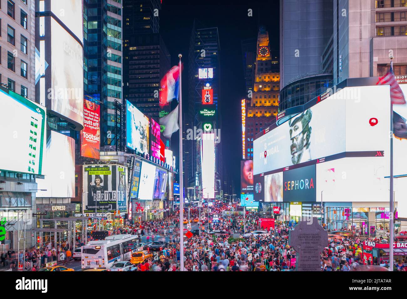 Large crowds gathered by night in Times Square in Midtown Manhattan ...