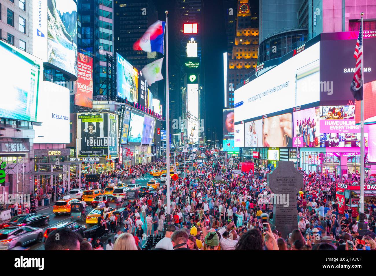 Large crowds gathered by night in Times Square in Midtown Manhattan ...