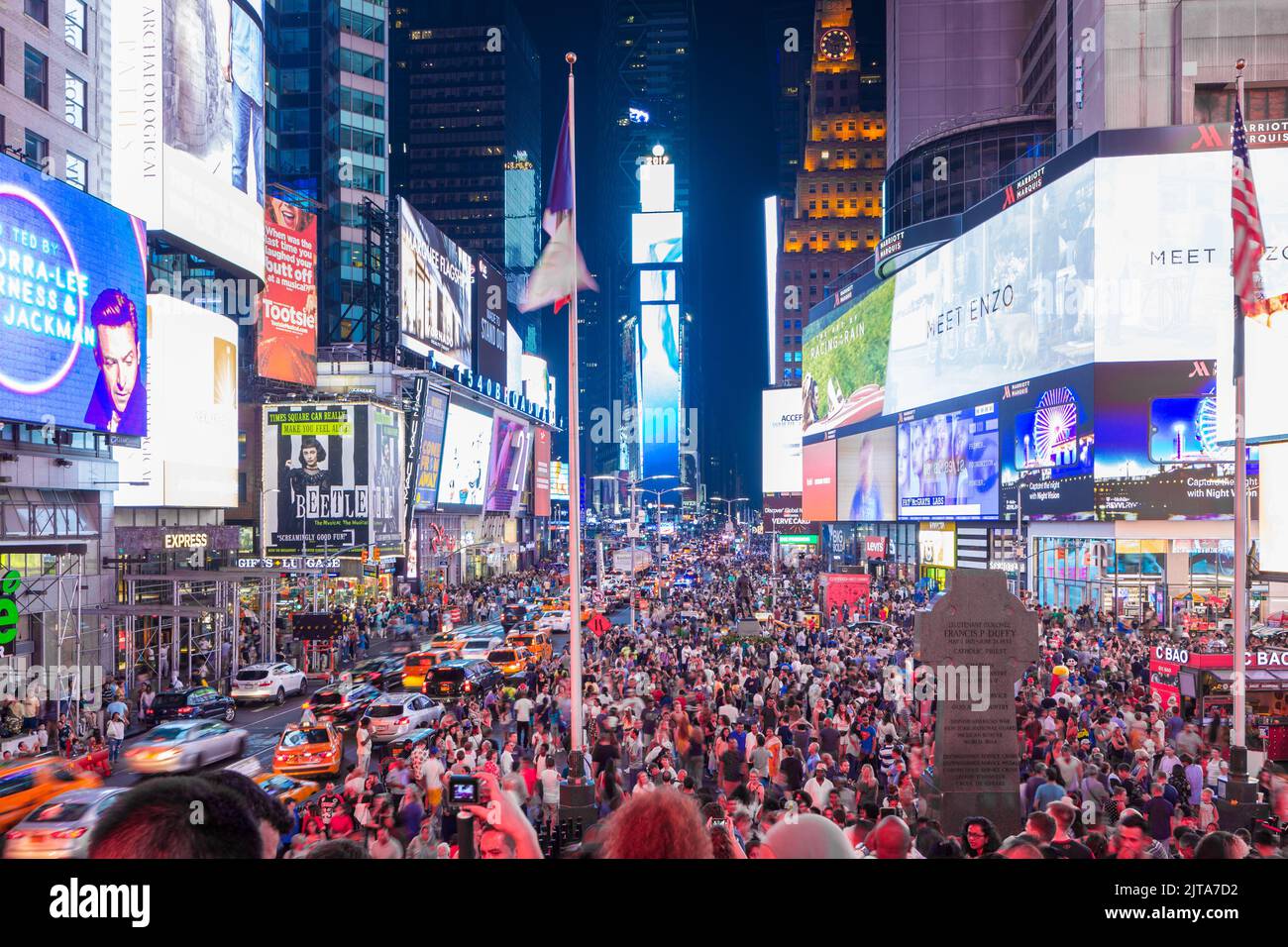 Large crowds gathered by night in Times Square in Midtown Manhattan ...
