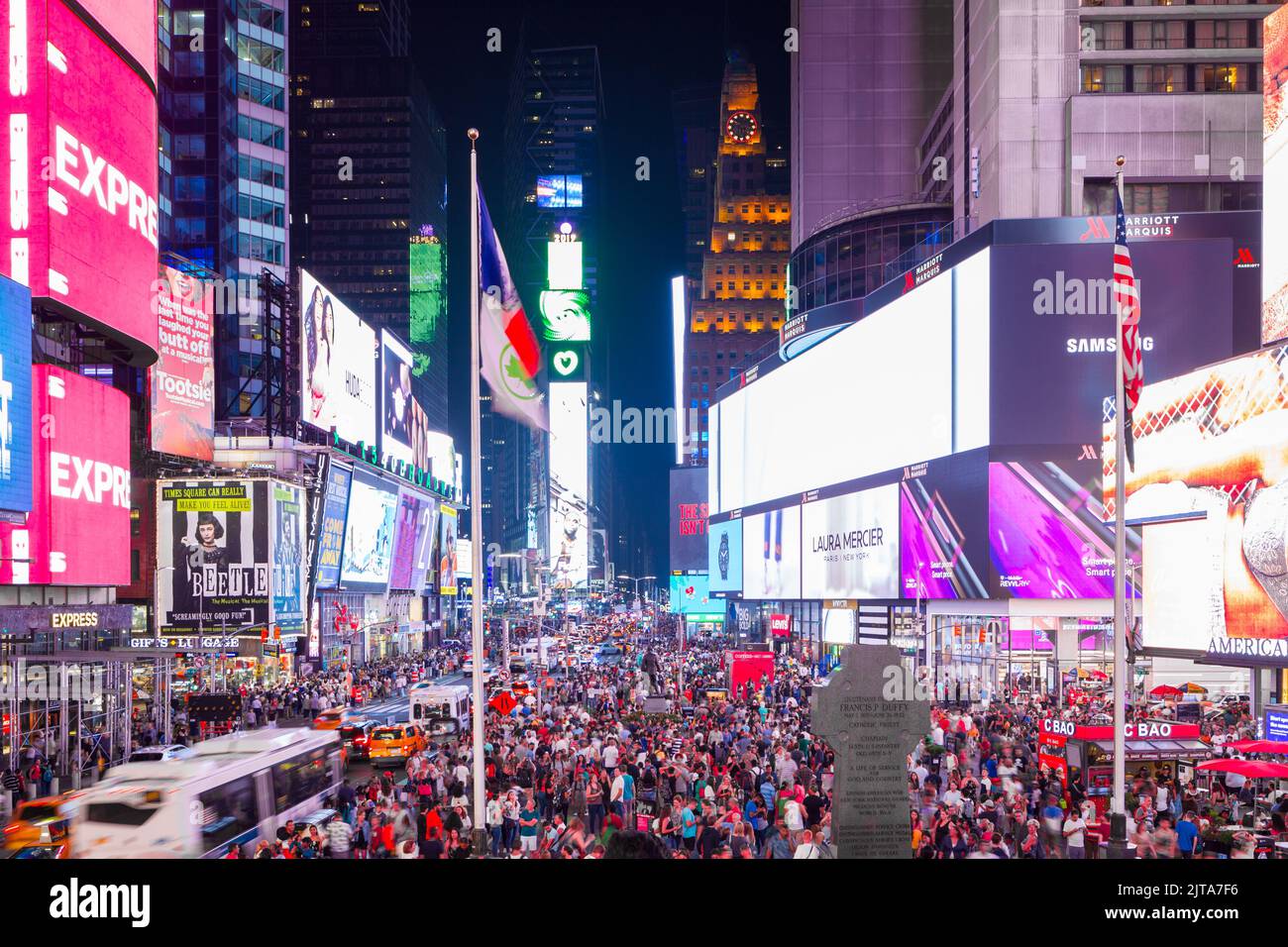 Large crowds gathered by night in Times Square in Midtown Manhattan ...