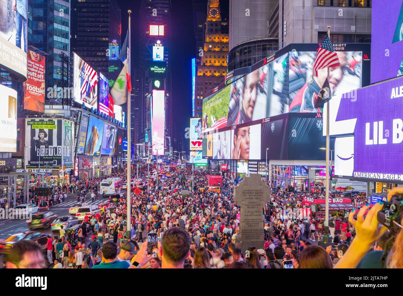 Large crowds gathered by night in Times Square in Midtown Manhattan ...
