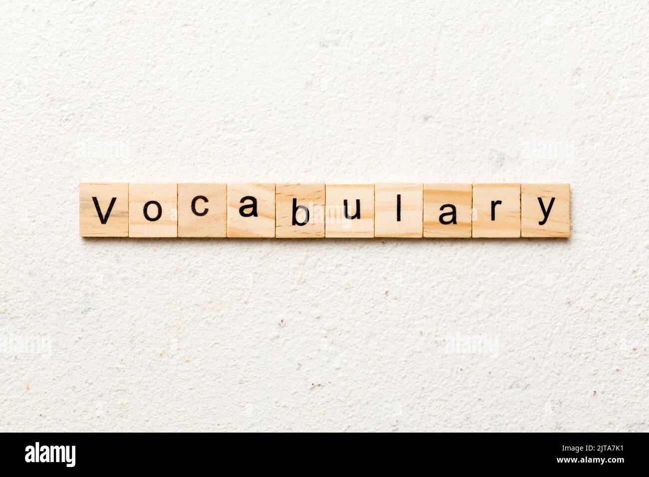vocabulary word written on wood block. vocabulary text on table ...