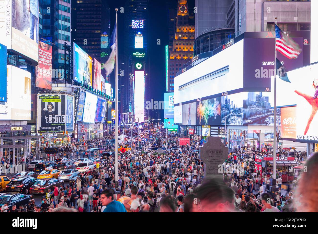 Large crowds gathered by night in Times Square in Midtown Manhattan ...