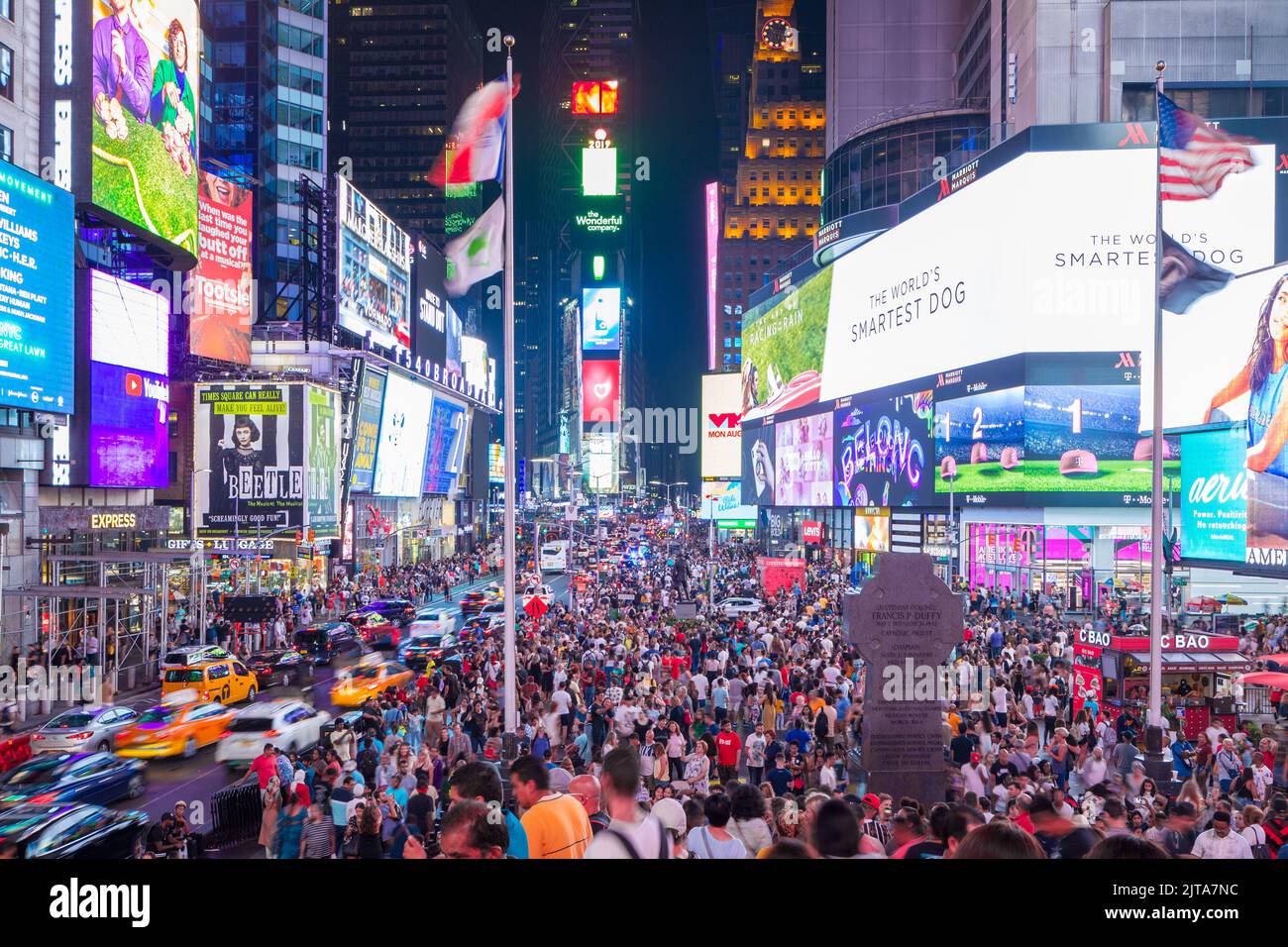 Large crowds gathered by night in Times Square in Midtown Manhattan ...