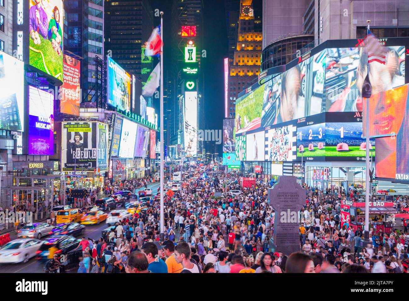 Large crowds gathered by night in Times Square in Midtown Manhattan ...
