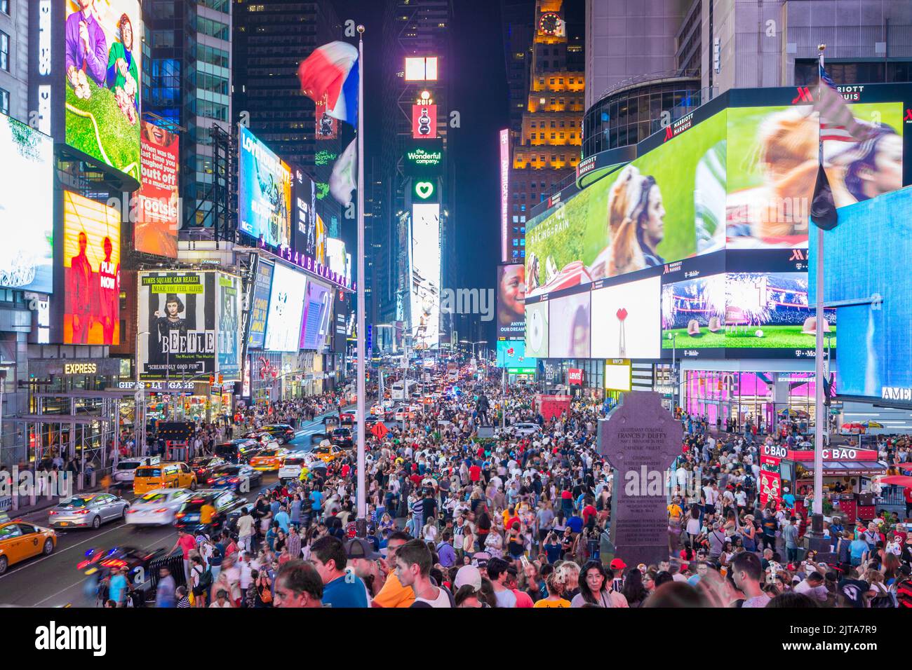 Large crowds gathered by night in Times Square in Midtown Manhattan ...