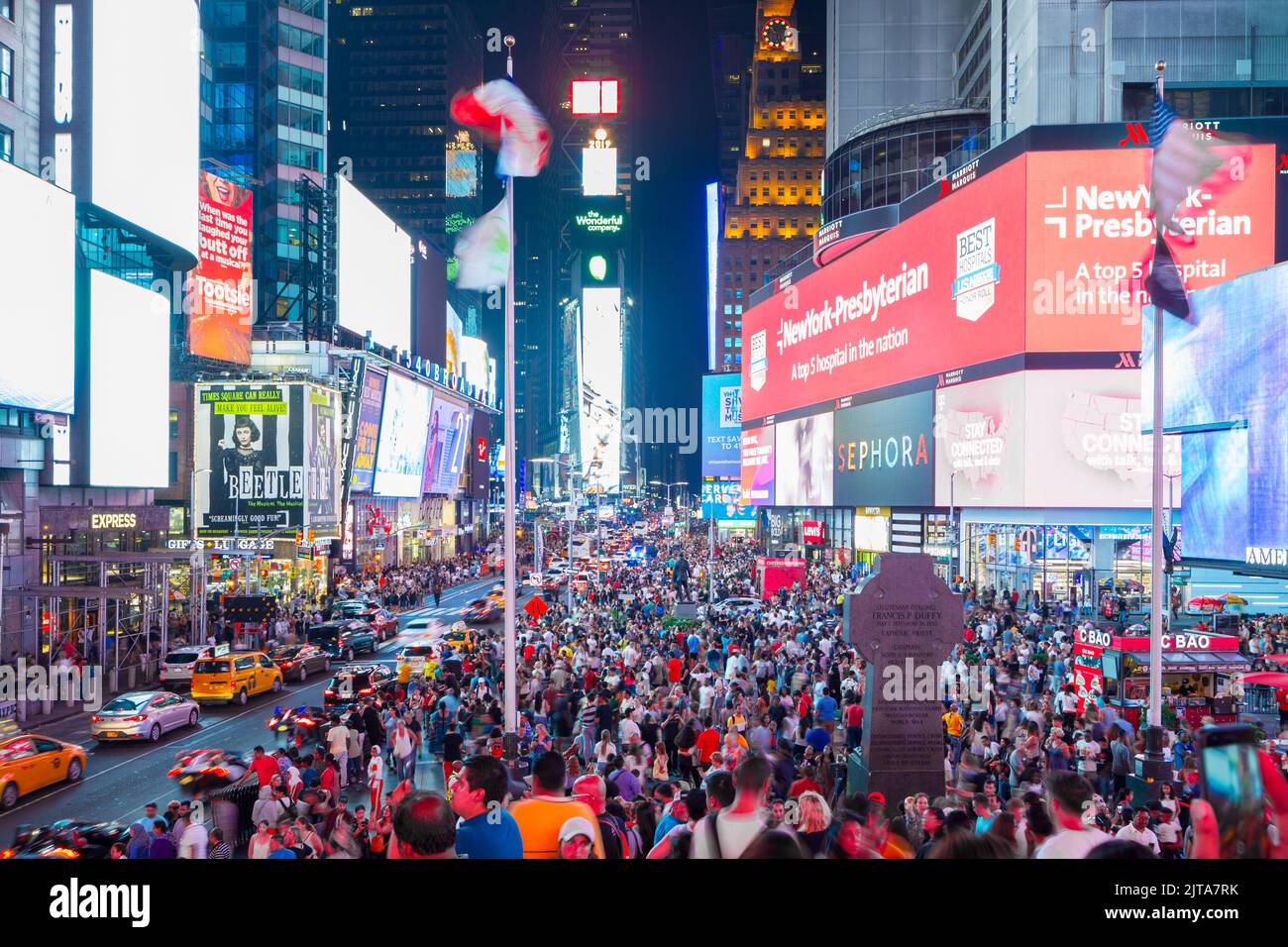 Large crowds gathered by night in Times Square in Midtown Manhattan ...