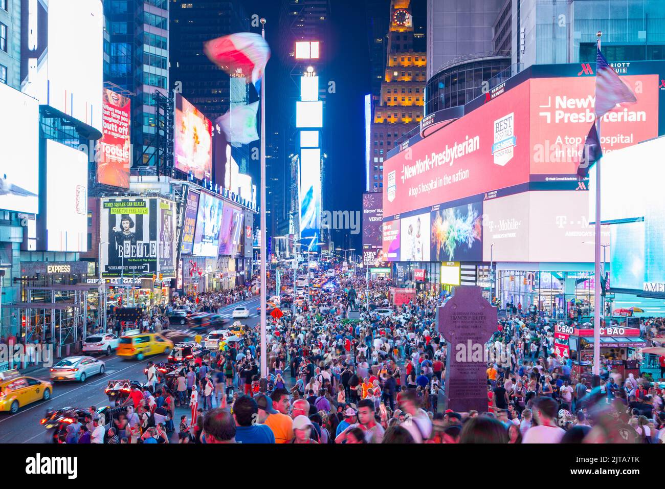 Large crowds gathered by night in Times Square in Midtown Manhattan ...
