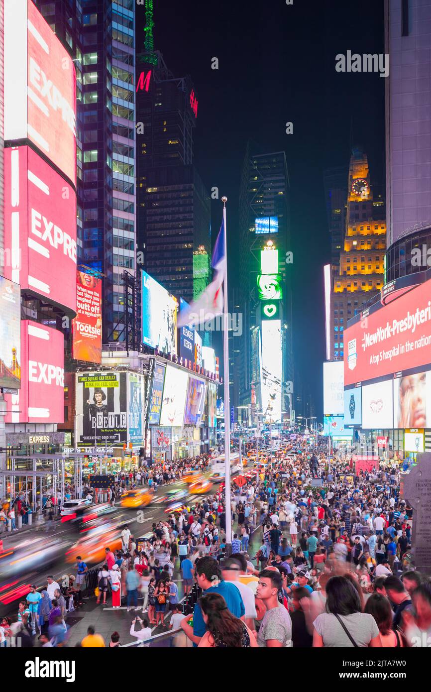 Large crowds gathered by night in Times Square in Midtown Manhattan ...
