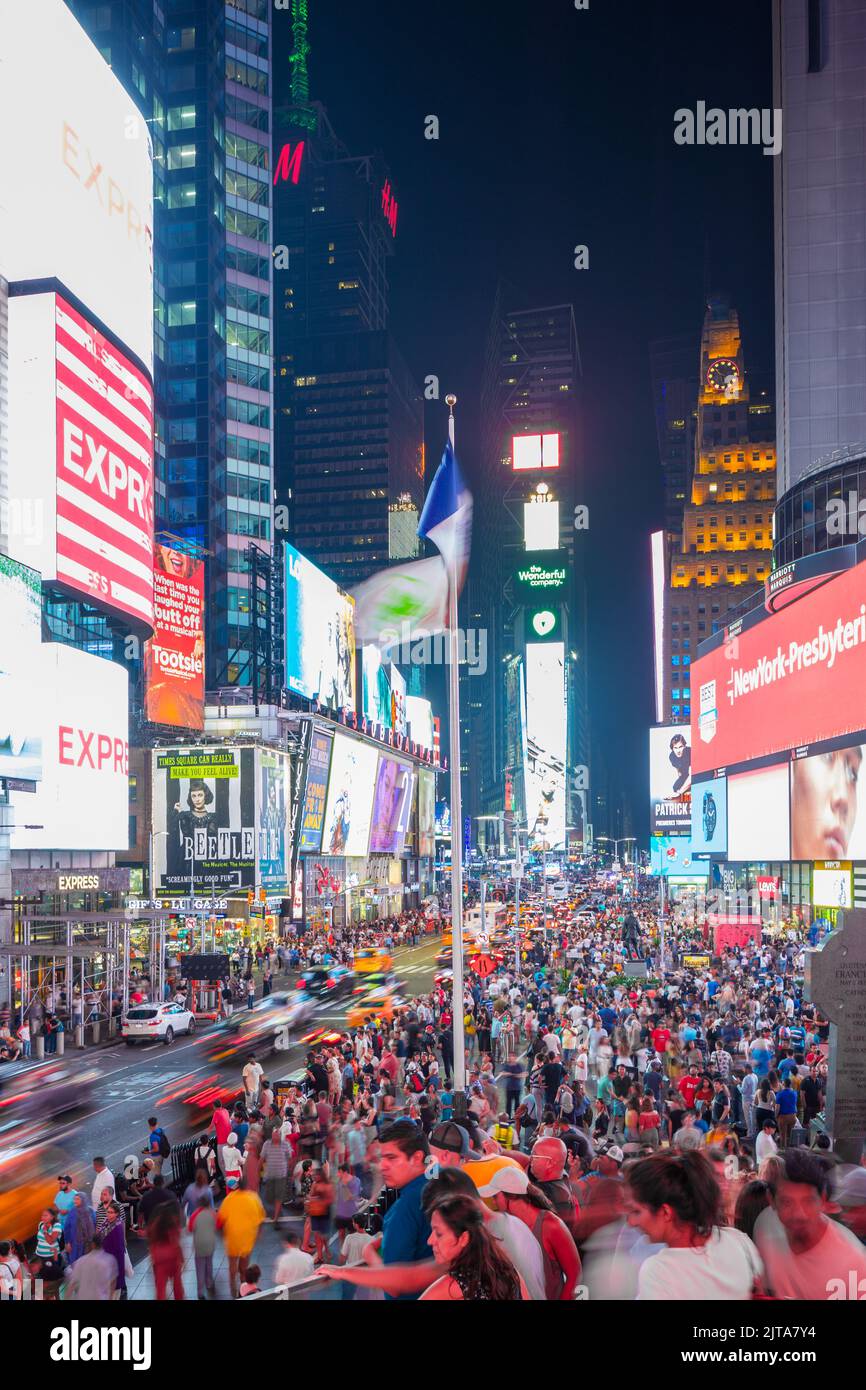 Large crowds gathered by night in Times Square in Midtown Manhattan ...