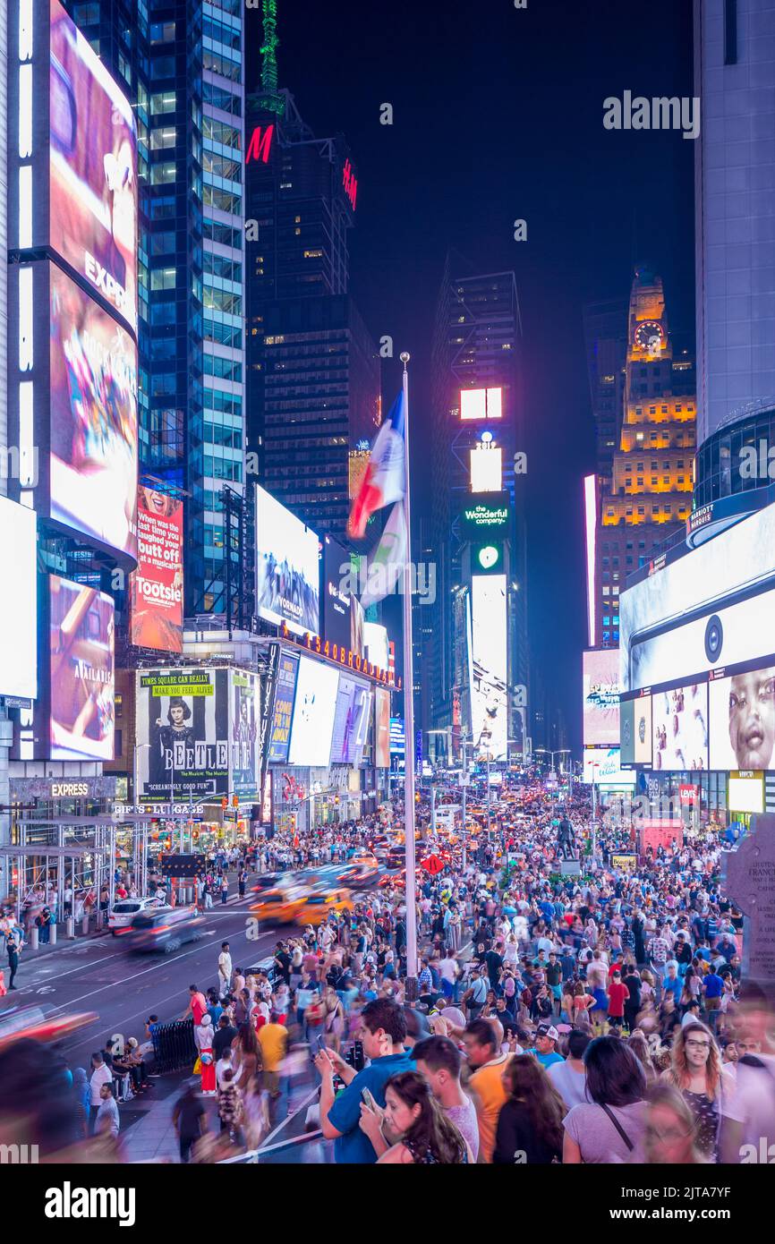 Large crowds gathered by night in Times Square in Midtown Manhattan ...