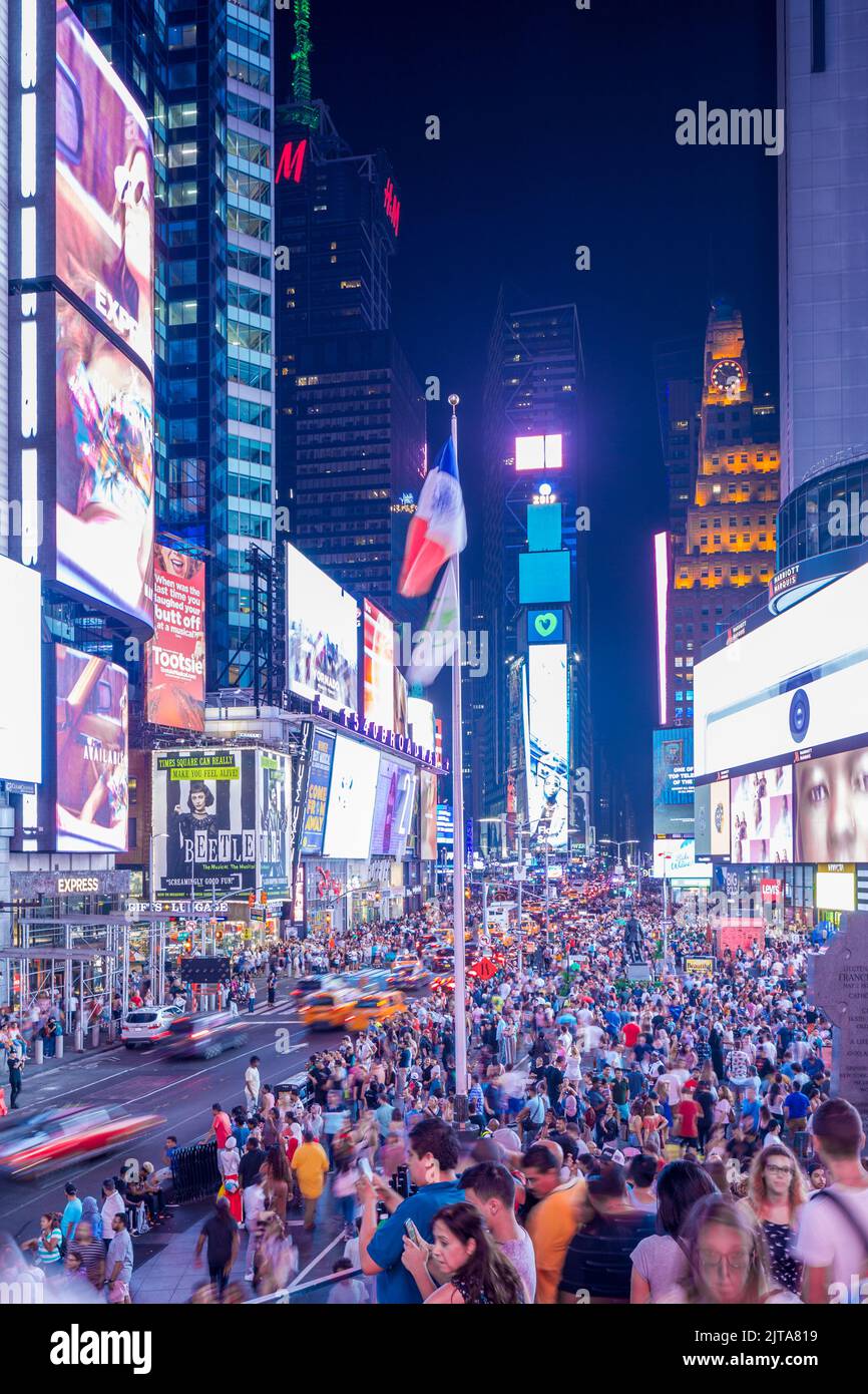 Large crowds gathered by night in Times Square in Midtown Manhattan ...