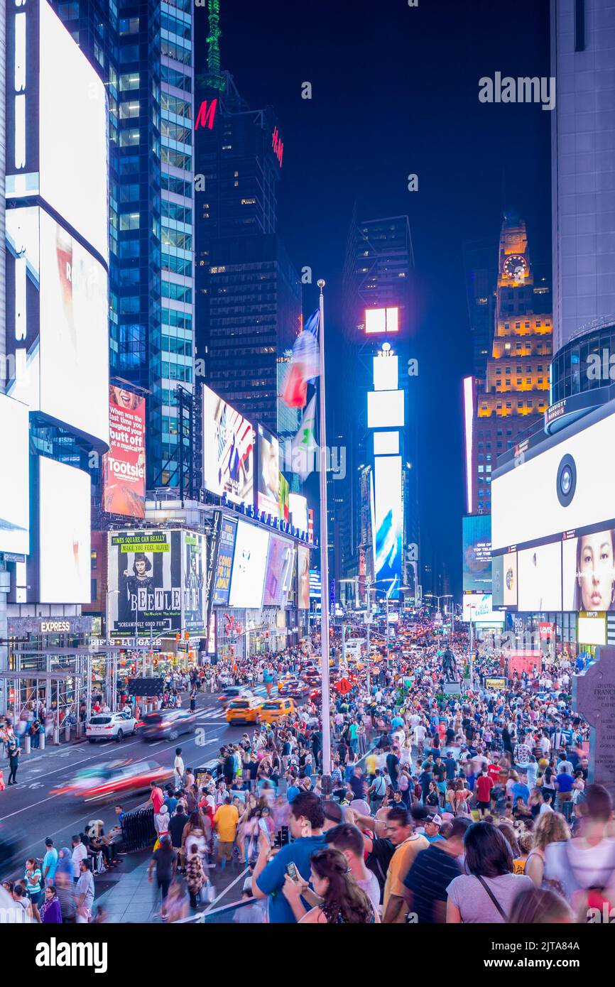 Large crowds gathered by night in Times Square in Midtown Manhattan ...
