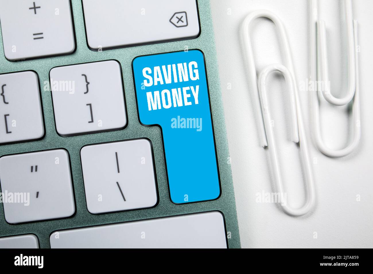Saving Money. Computer keyboard on a white office table Stock Photo - Alamy